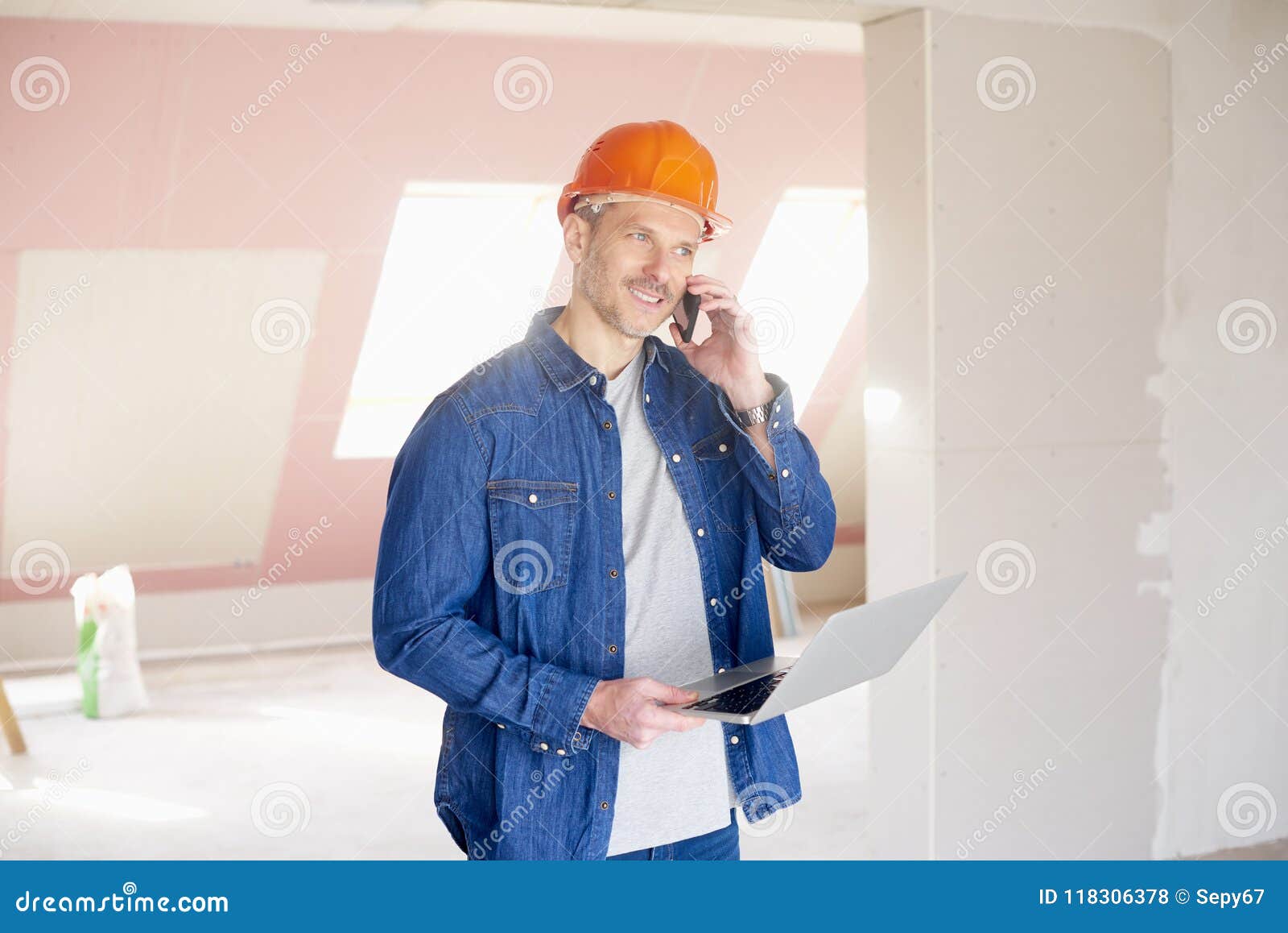 Construction Worker Using Laptop and Mobile Phone Stock Photo - Image ...