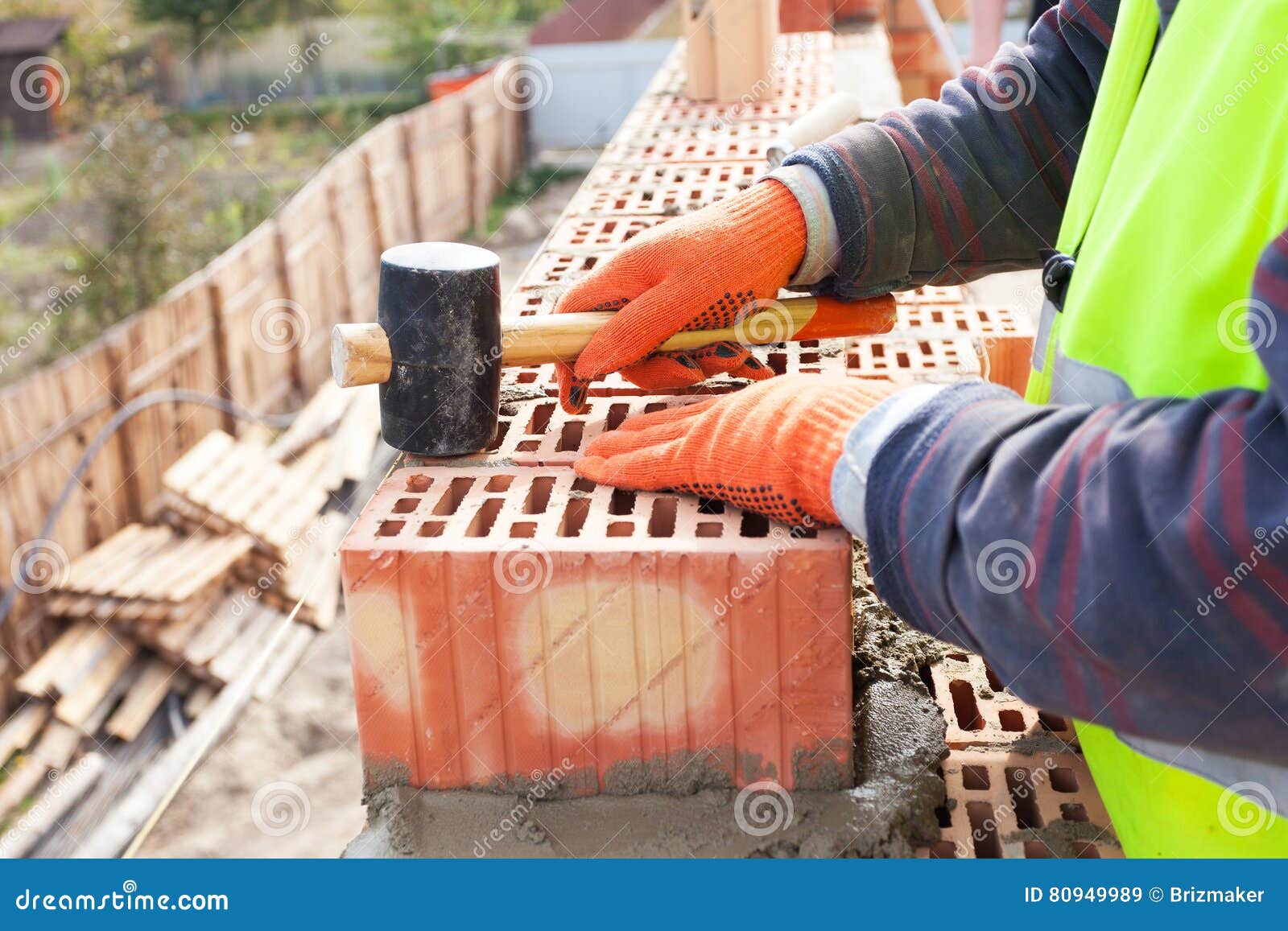 Construction Mason Worker Bricklayer Installing Red Brick with Rubber ...