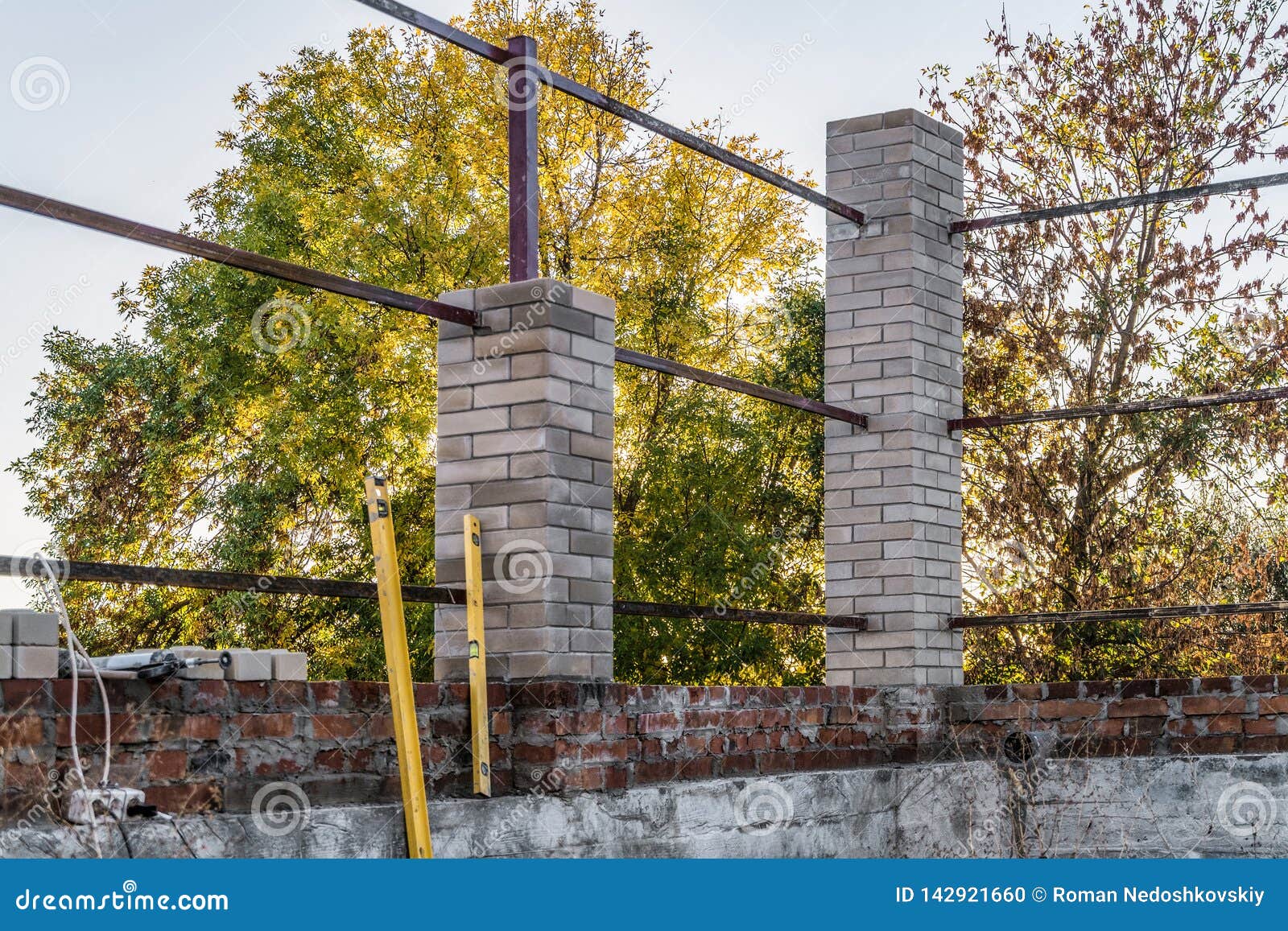 Construction of a Metal Frame Fence with Brick Posts Stock Photo ...