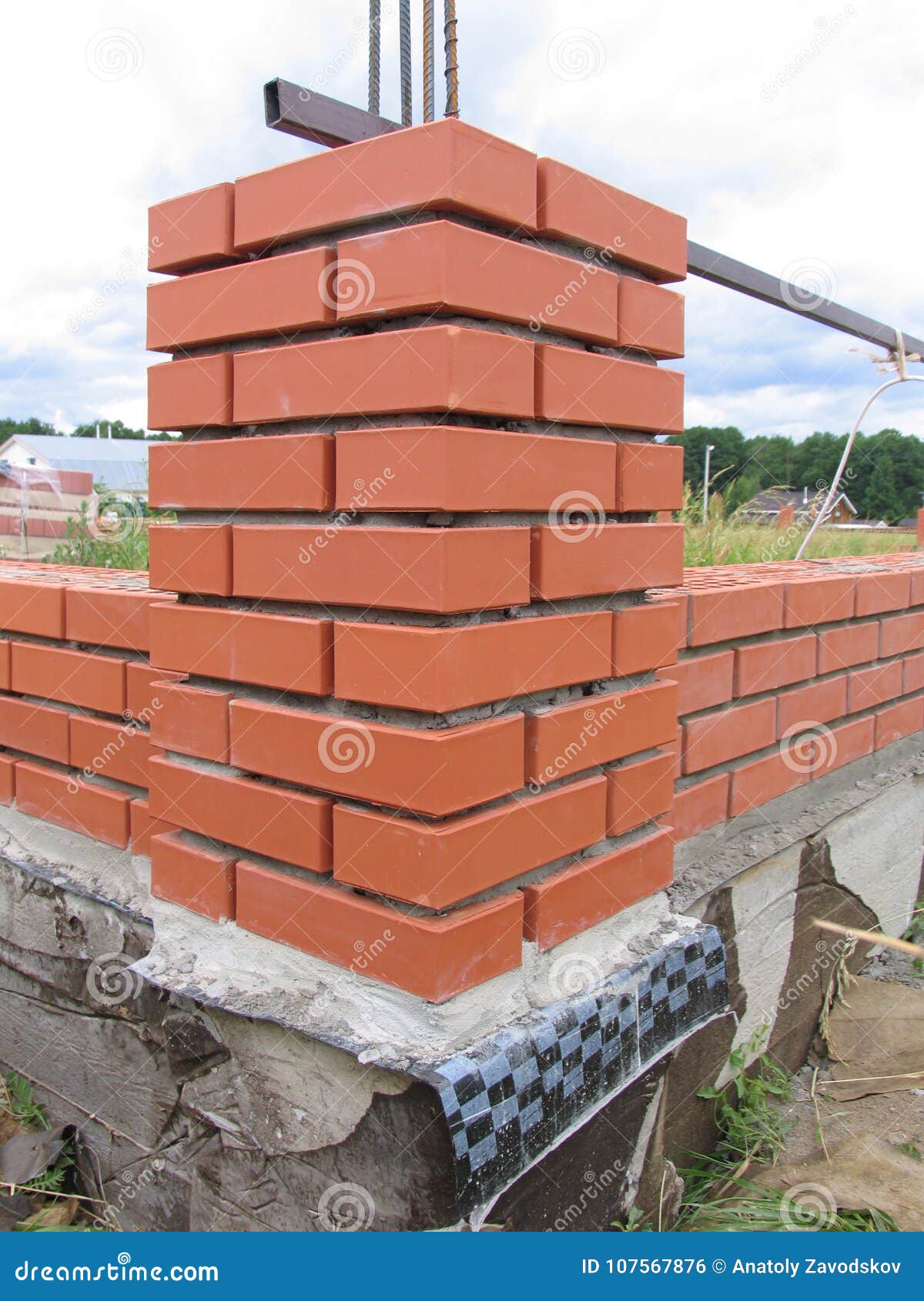 A Brick Fence With Lanterns And Wooden Sliding Gate In The Paver Block ...