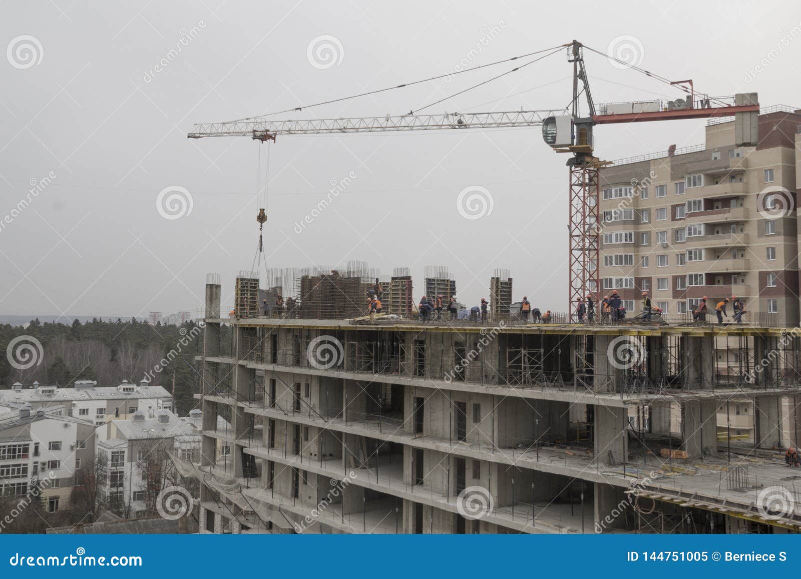Construction of a Multi-storey Building, a Crane at a Construction Site ...