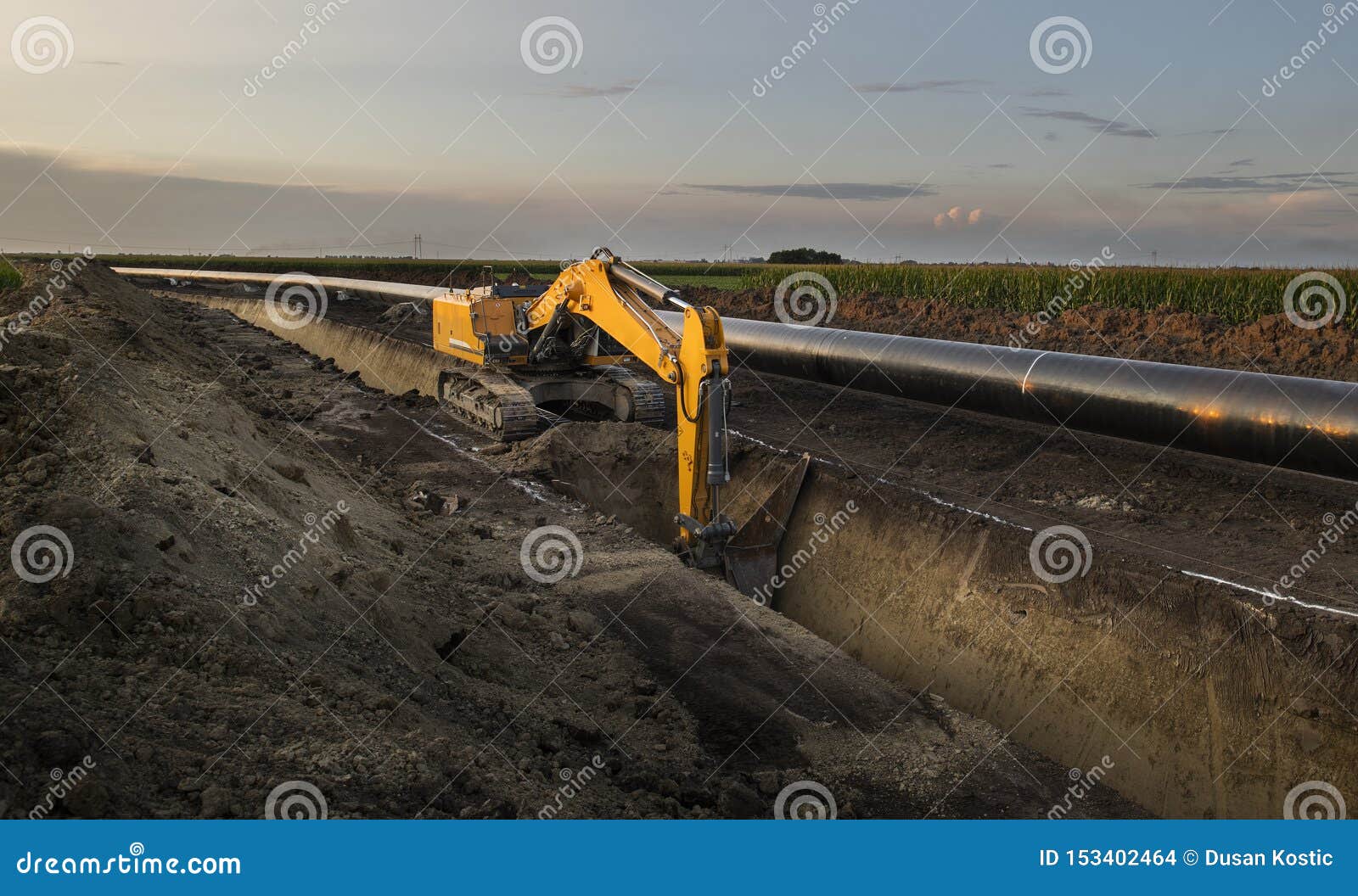 Crane Digging a Channel for Gas Pipeline Stock Photo - Image of ...
