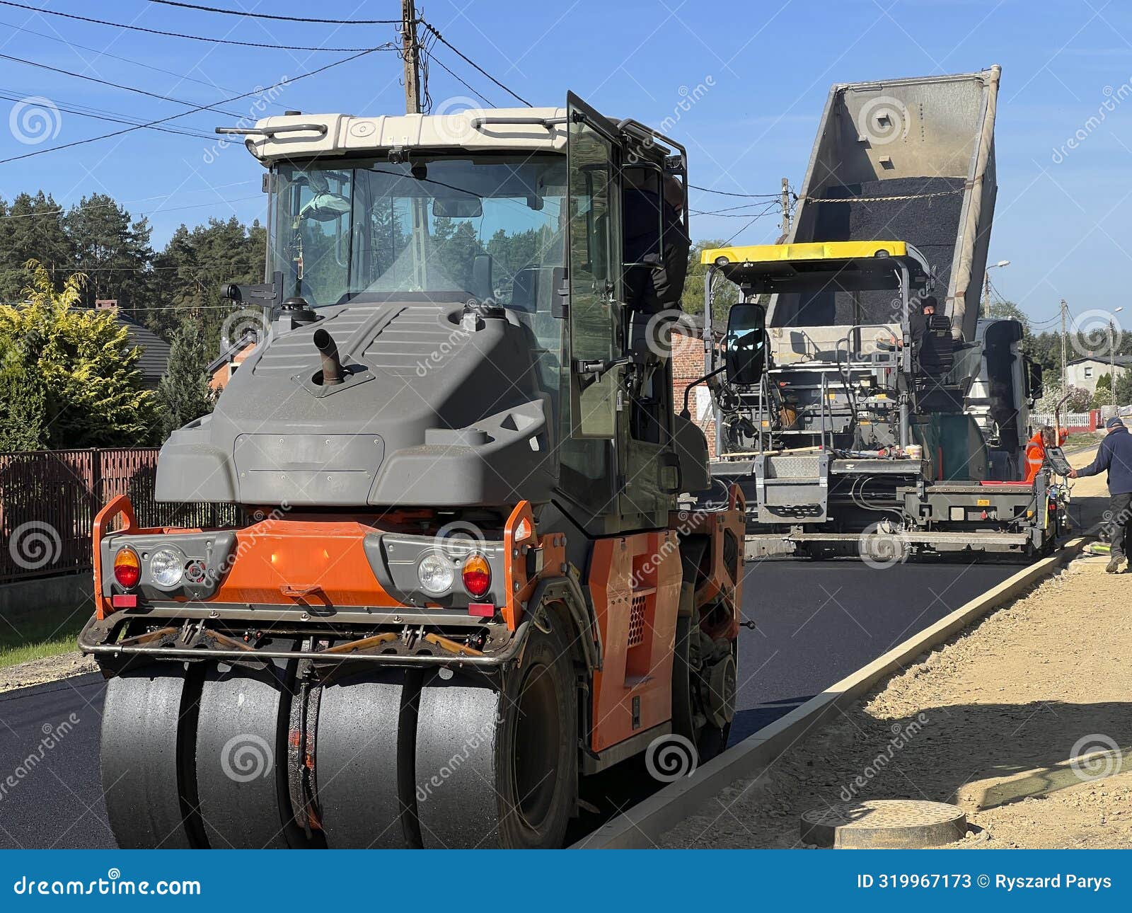 Construction of a New Street Surface. Laying a Layer of Asphalt with a ...