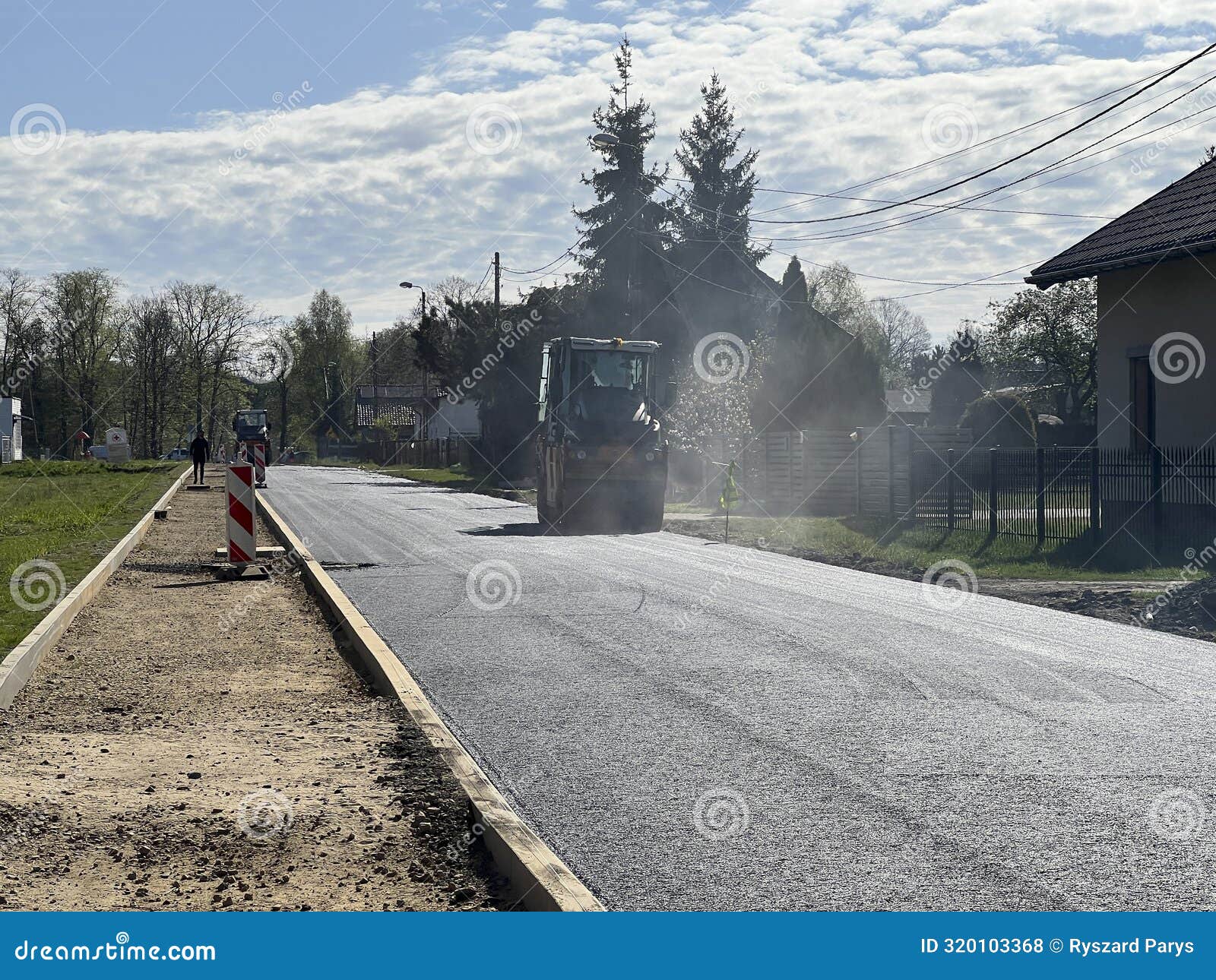 Construction of a New Street Surface. Laying a Layer of Asphalt with a ...