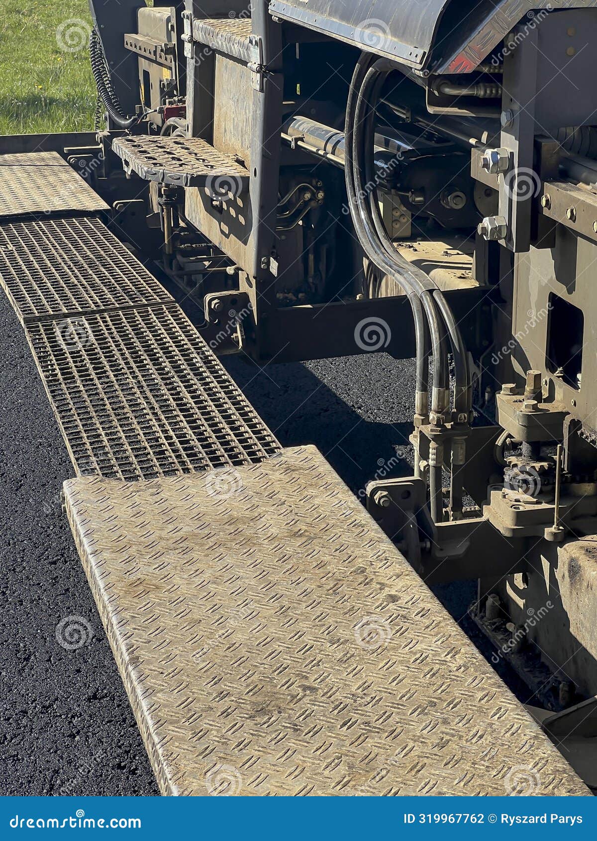 Construction of a New Street Surface. Laying a Layer of Asphalt with a ...