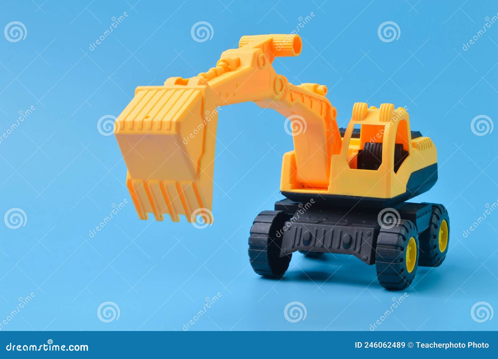 Construction Plastic Backhoe Tractor Toy Isolated On A Blue Background ...