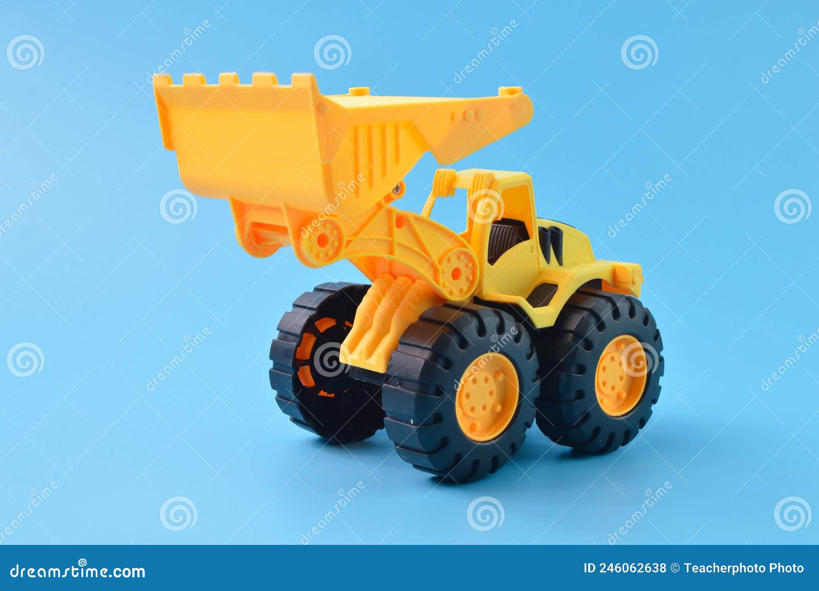 Construction Plastic Backhoe Tractor Toy Isolated on a Blue Background ...