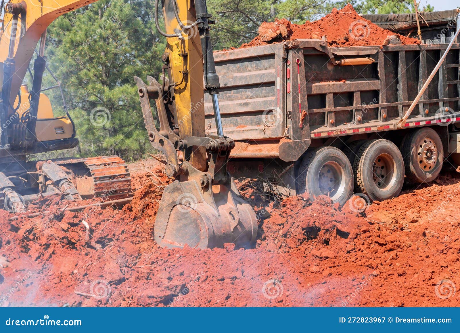 During the Construction Process, an Excavator is Loading Earth into a ...