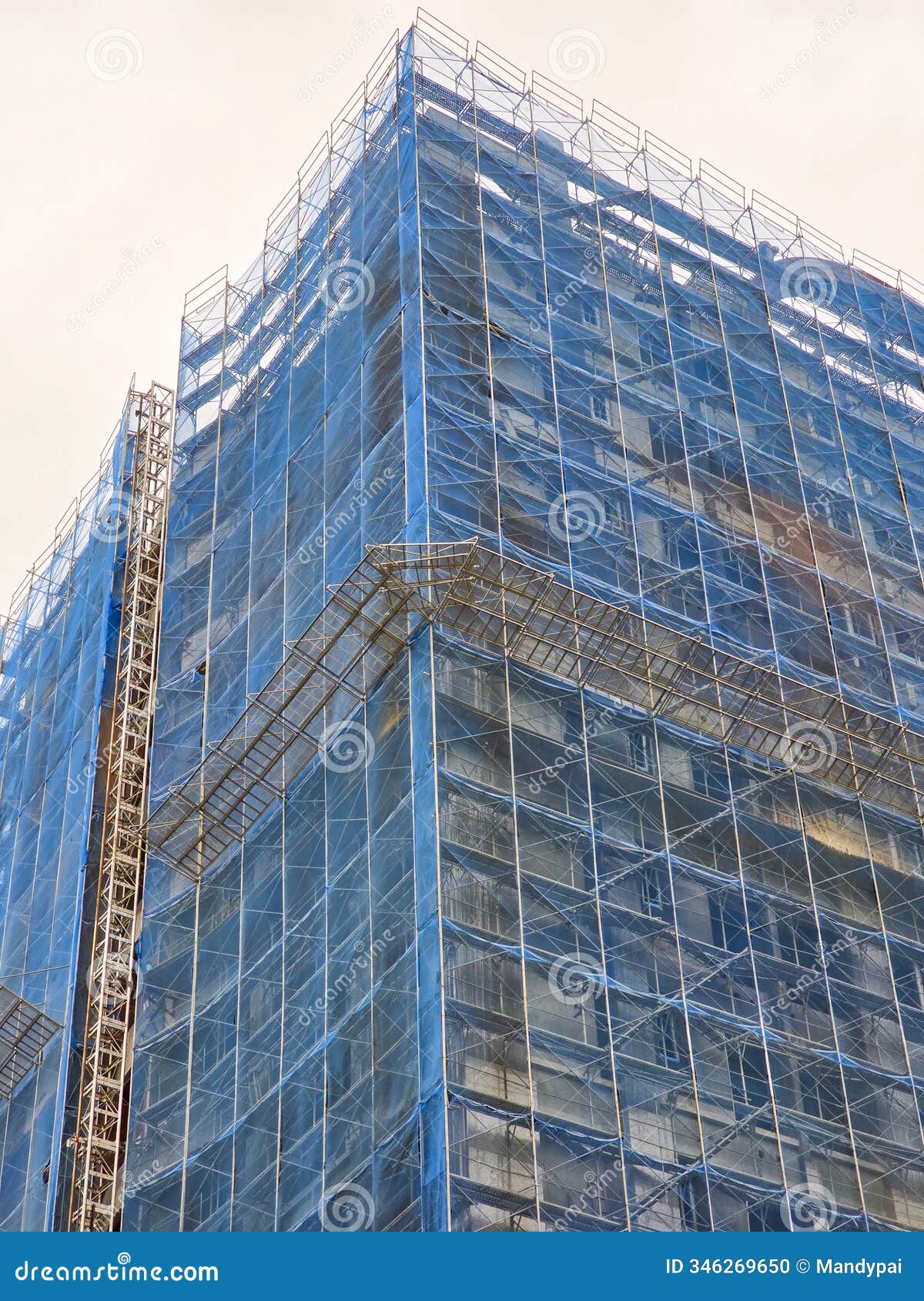 Construction in Progress: Building with Scaffolding and Blue Drapes ...