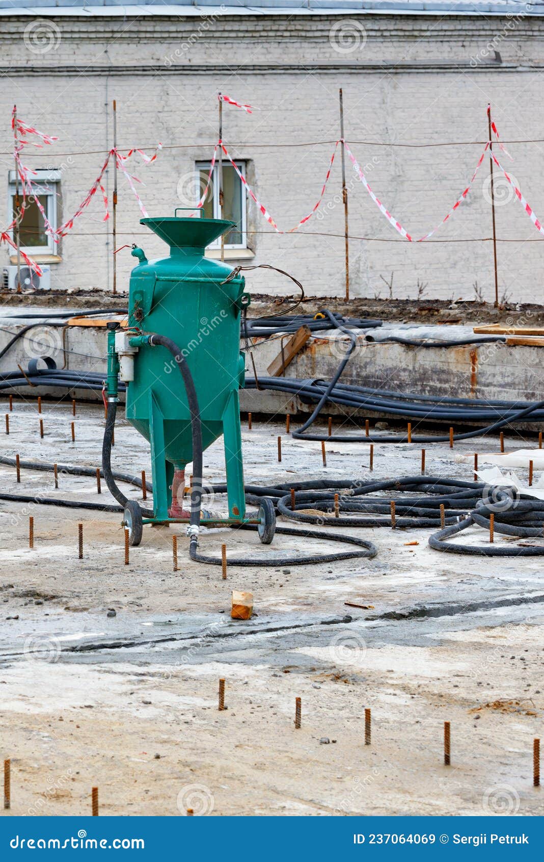 A Construction Sandblasting Machine Stands On A Work Platform For ...