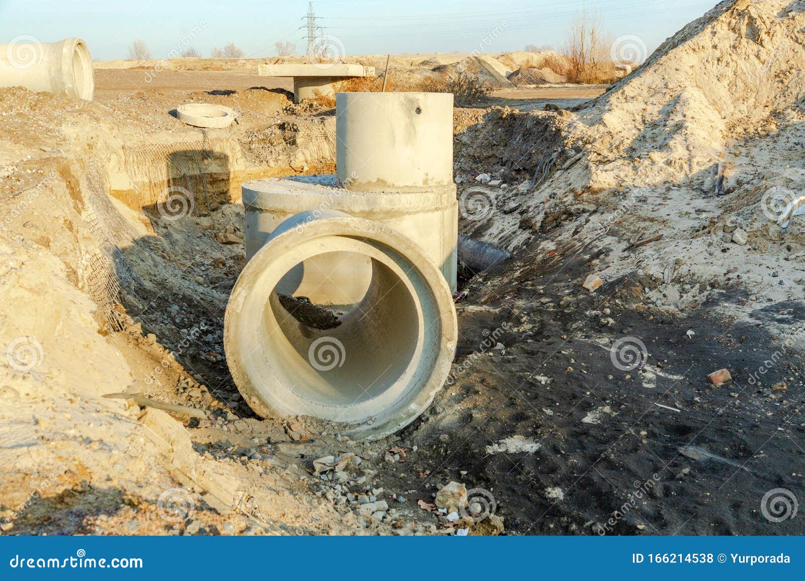 Construction of Sewage with Concrete Pipes in the Pit Against the Blue ...