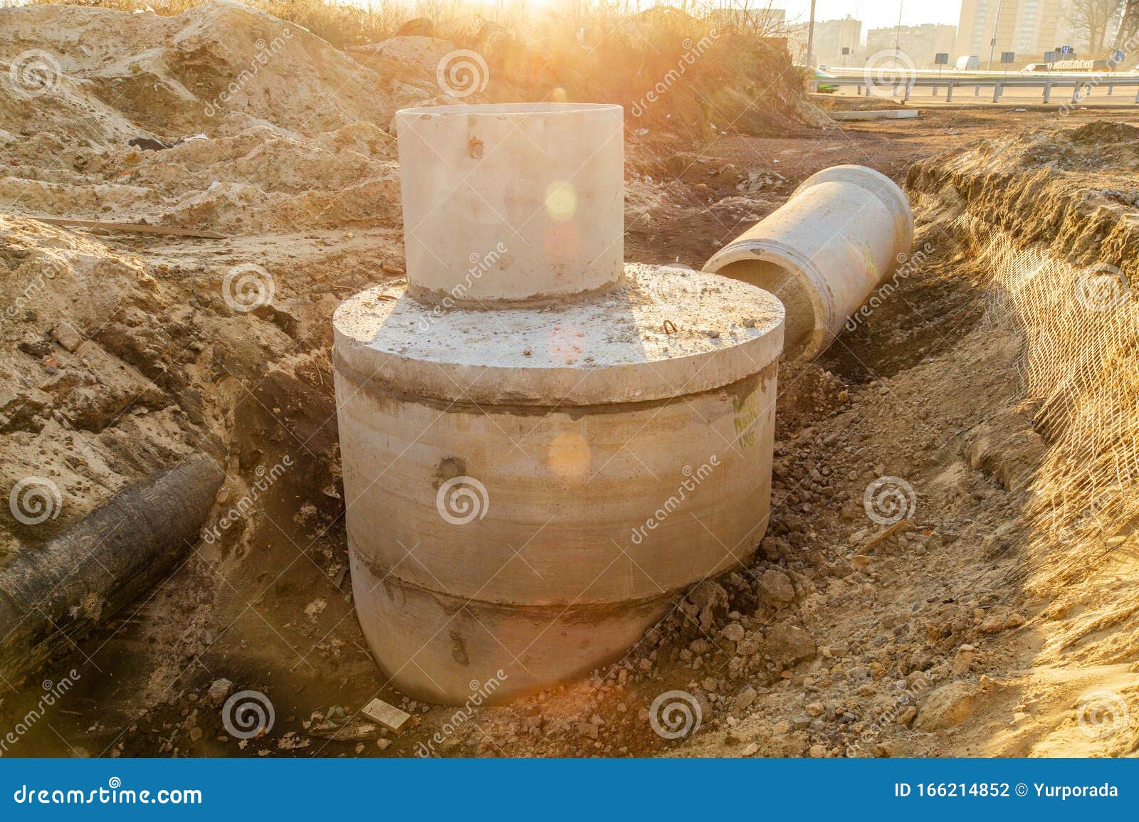 Construction of Sewage with Concrete Pipes in the Pit on the Background ...