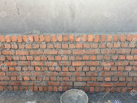 Construction of a Single Line Red Bricks by Applying Cement in between ...