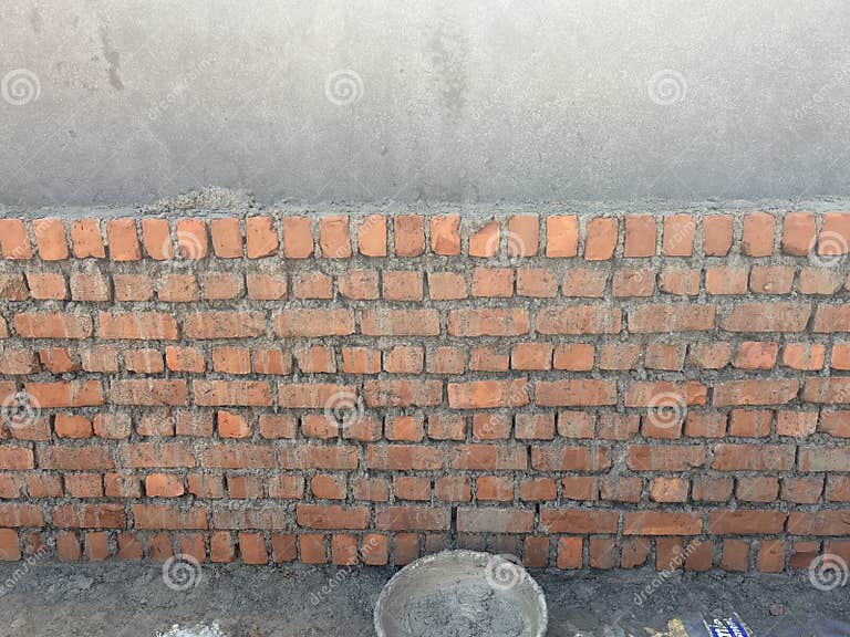 Construction of a Single Line Red Bricks by Applying Cement in between ...