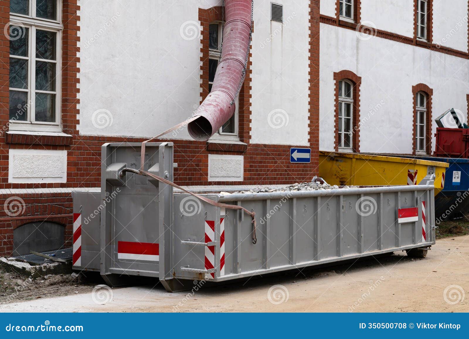 Construction Site Activity with Waste Disposal Container at Building ...
