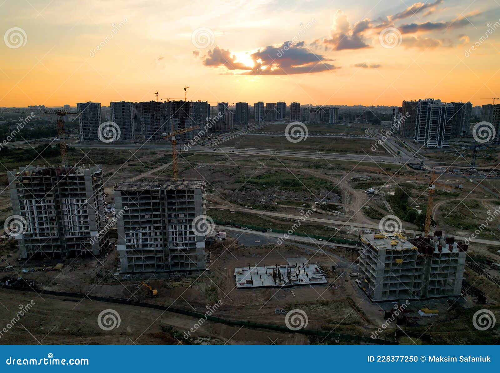 Construction Site Against the Backdrop of the Sunset. Tower Crane ...