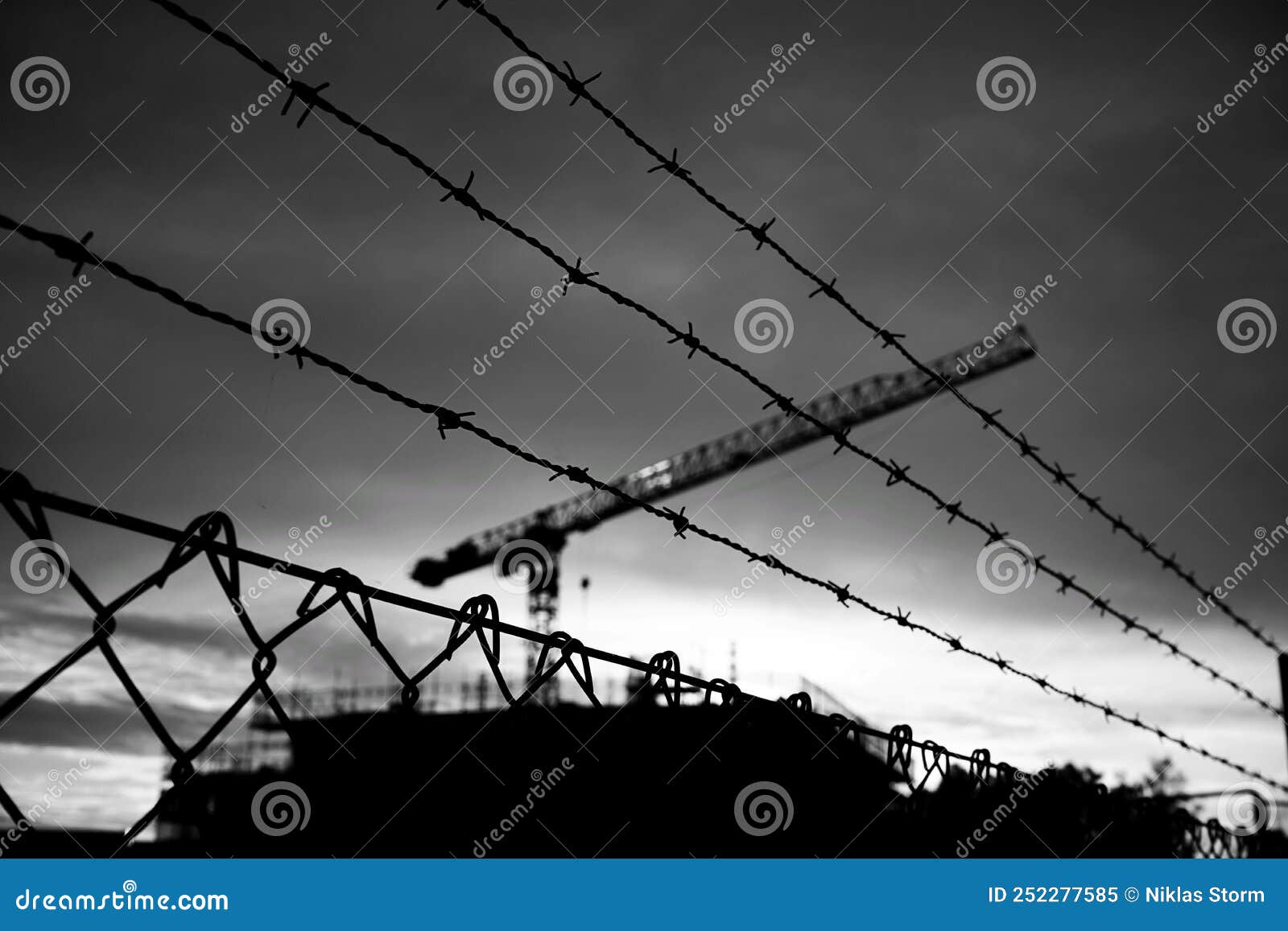 Construction Site Behind Barbed Wire in the Evening Stock Image - Image ...