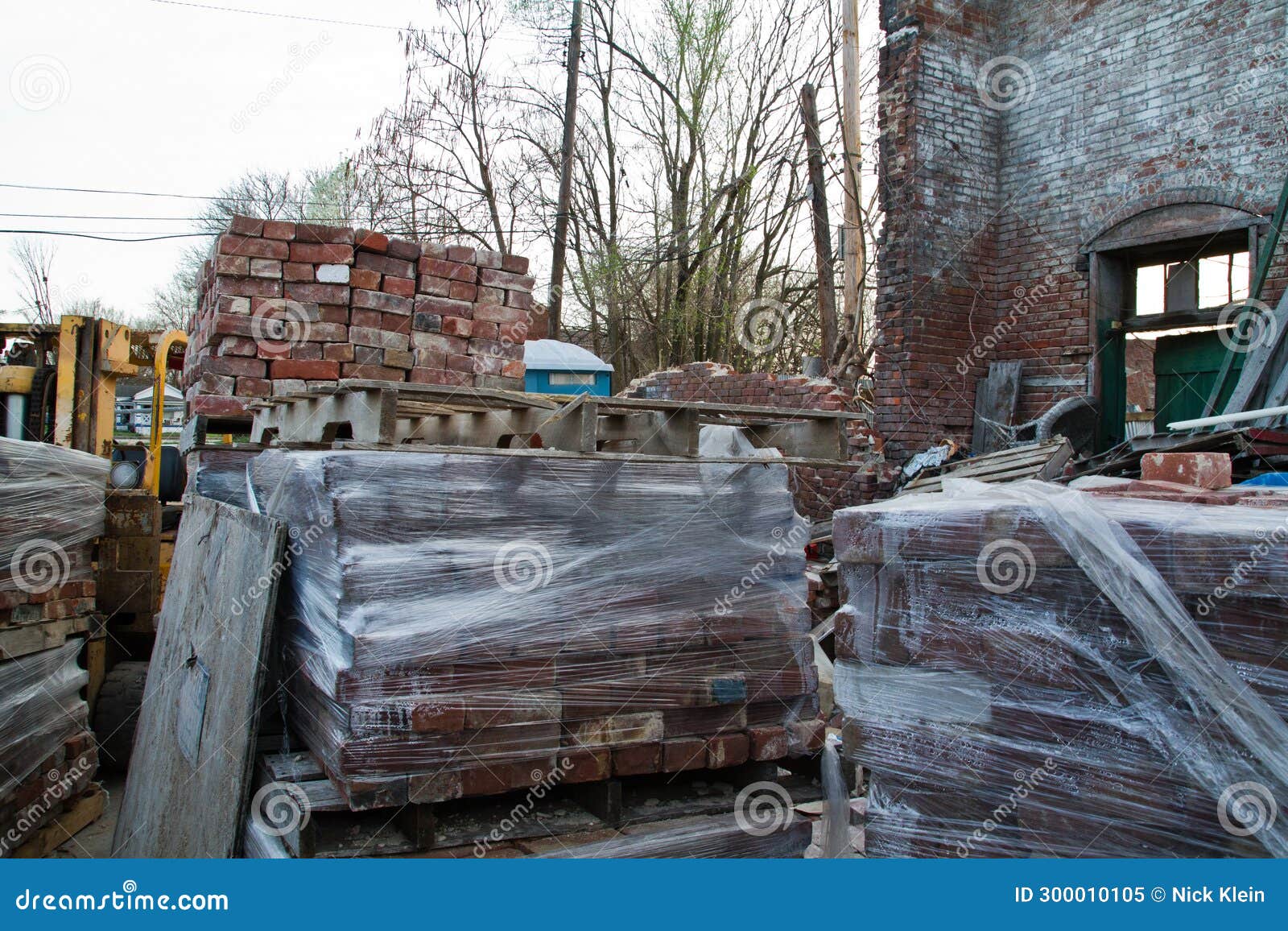 Construction Site Chaos with Bricks on Pallets and Forklift in Open ...