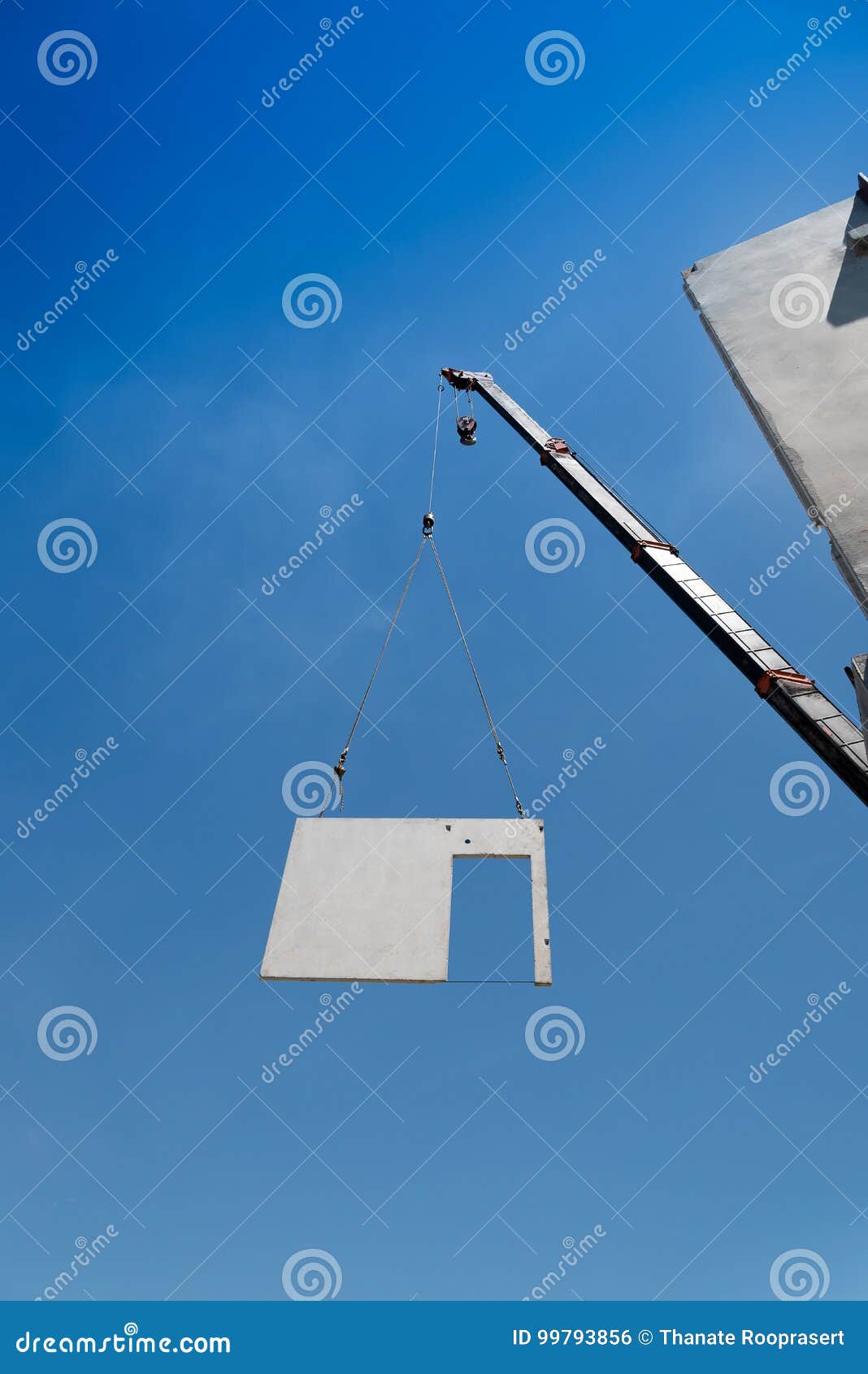 Construction Site Crane is Lifting a Precast Concrete Wall Panel Stock ...