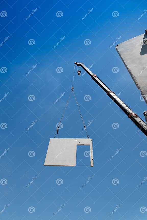 Construction Site Crane is Lifting a Precast Concrete Wall Panel Stock ...