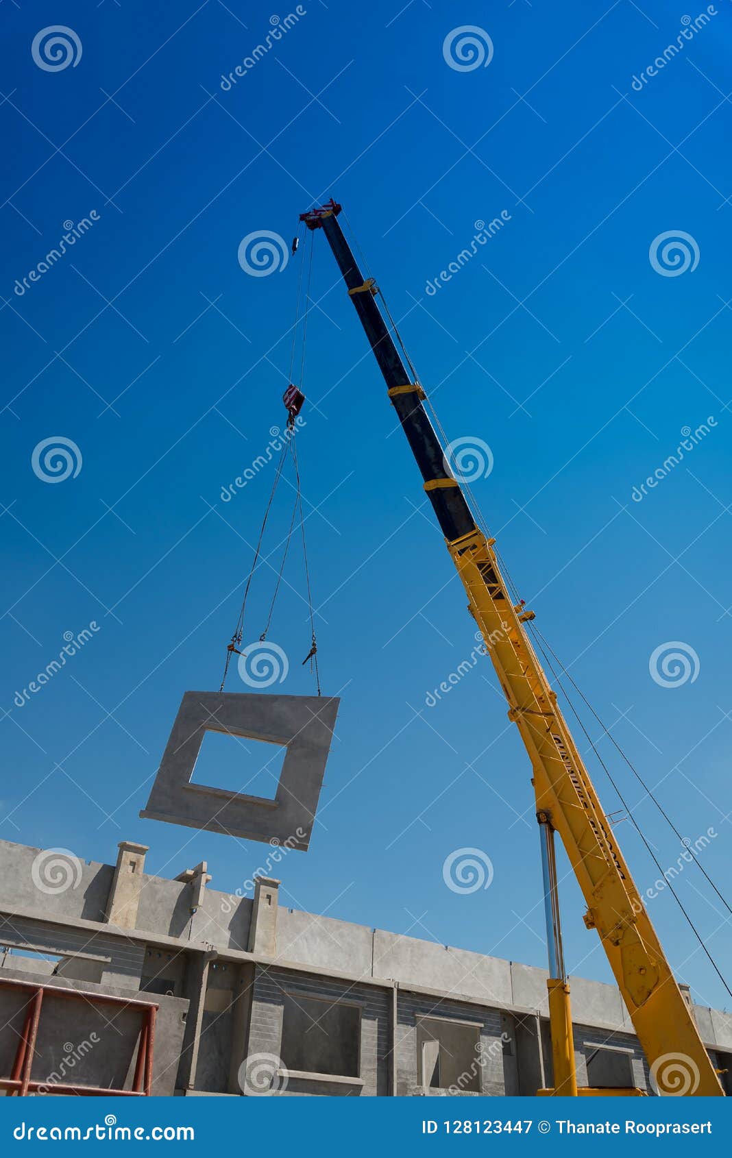 Construction Site Crane is Lifting a Precast Concrete Wall Panel Stock ...
