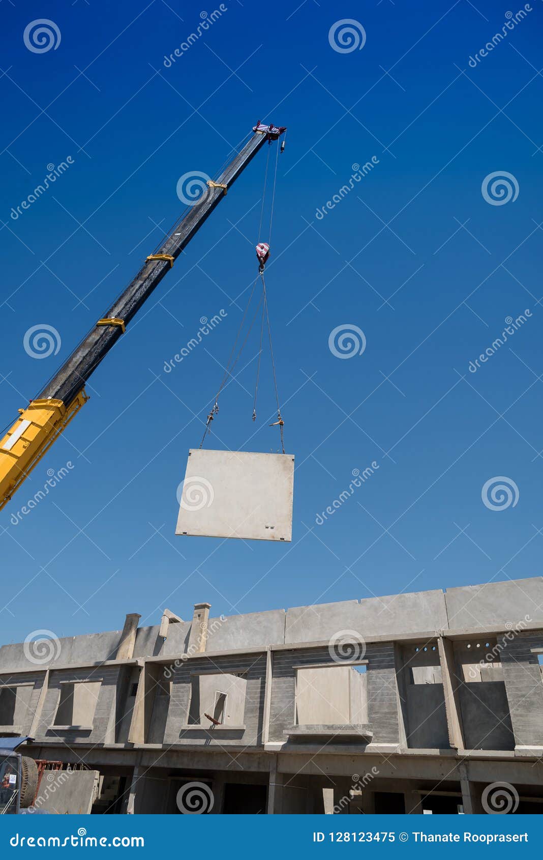 Construction Site Crane is Lifting a Precast Concrete Wall Panel Stock ...