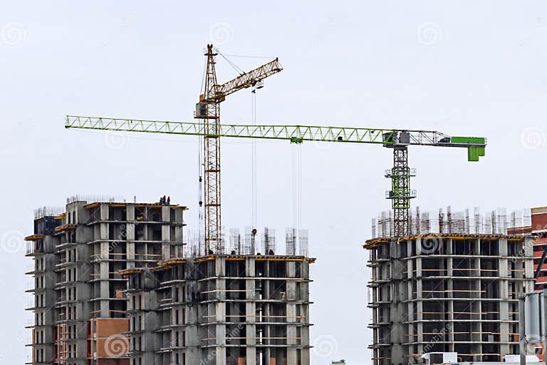 Construction Site with Cranes Assembling Concrete Structures Under Overcast Sky, Urban ...