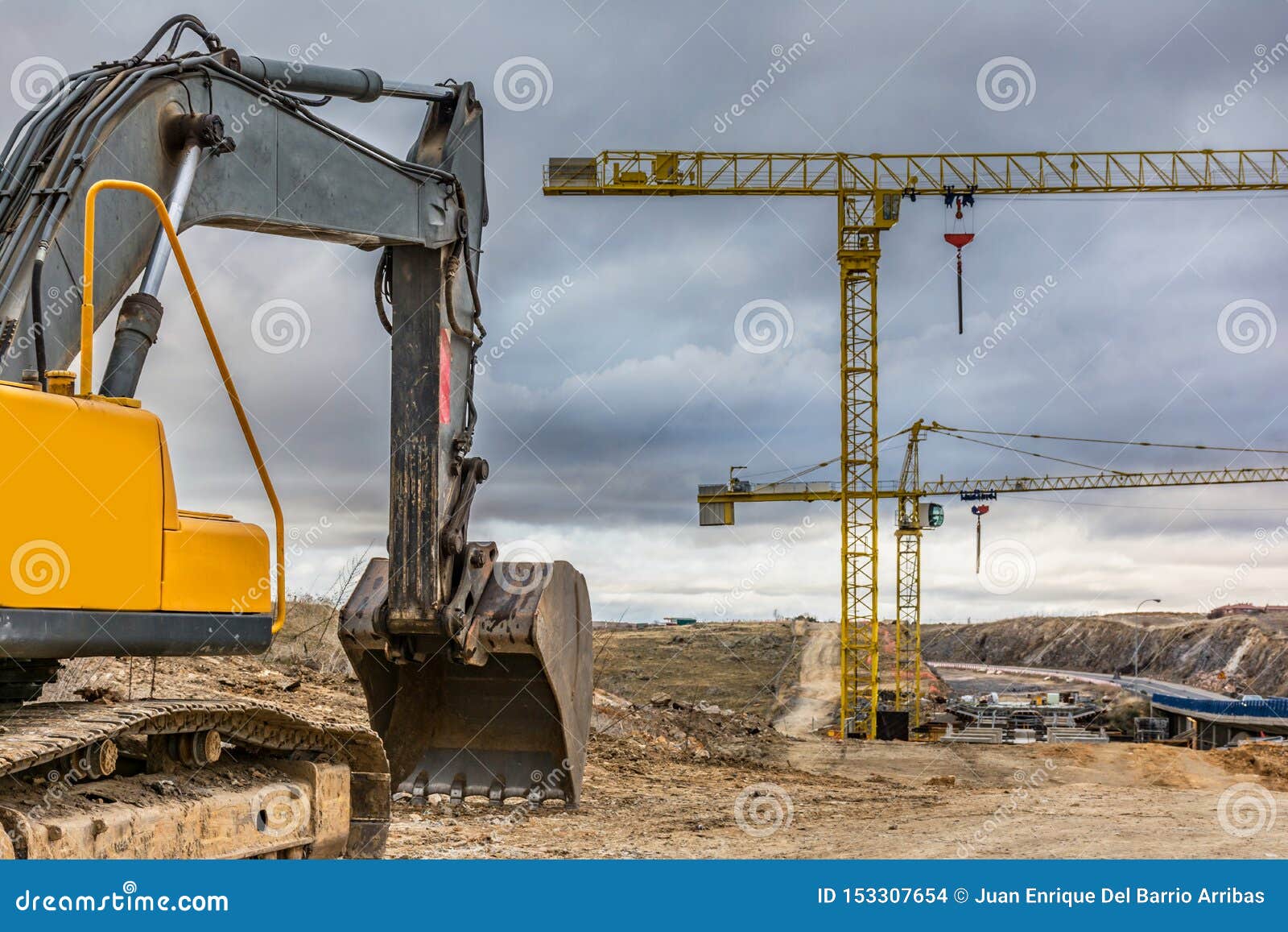 A Construction Site with Cranes and the Detail of the Shovel of an ...