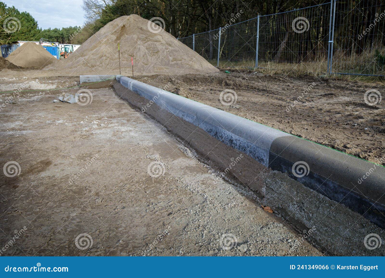 On the Construction Site the Curbs for a Road are Being Set Right Now ...