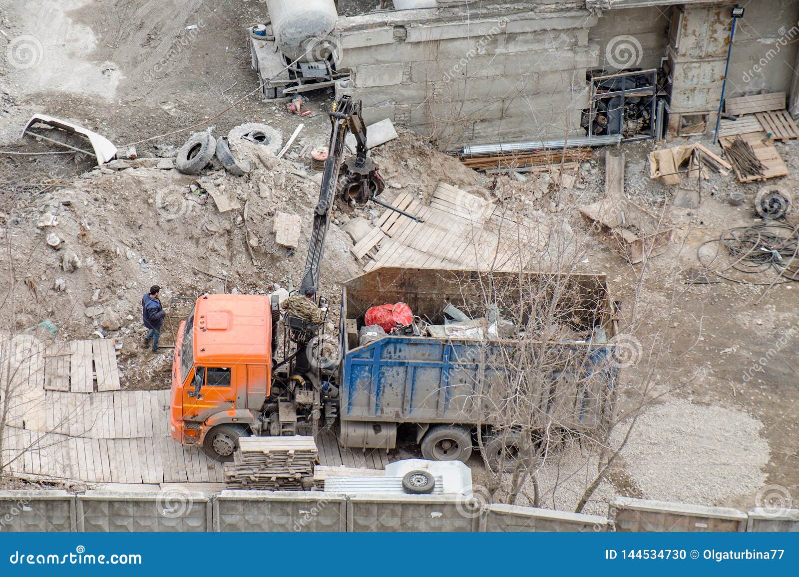 Construction Site Debris Removal. Truck with Crane Loading for Scrap ...