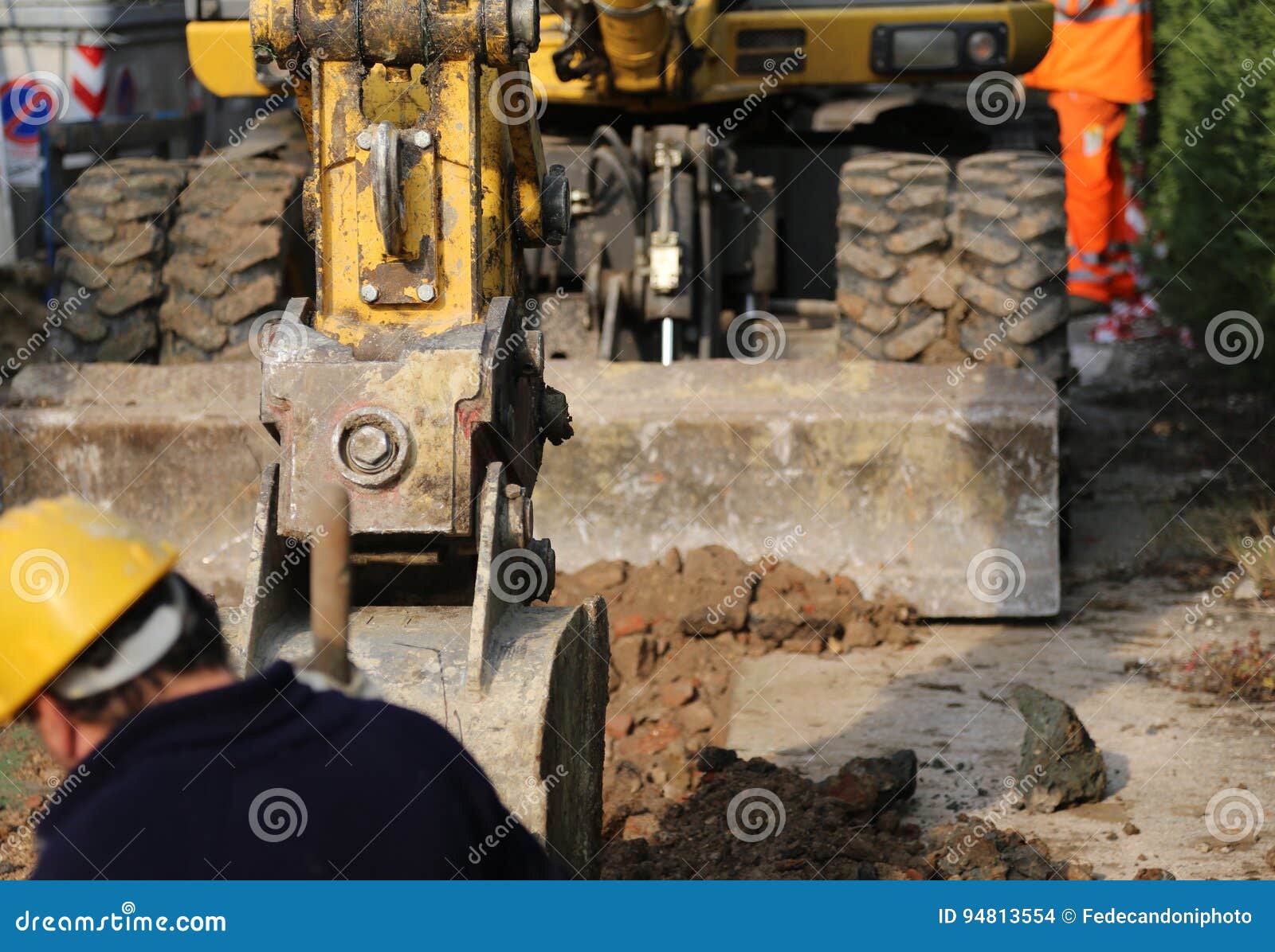 Construction Site with the Digger and the Worker Inside the Digg ...