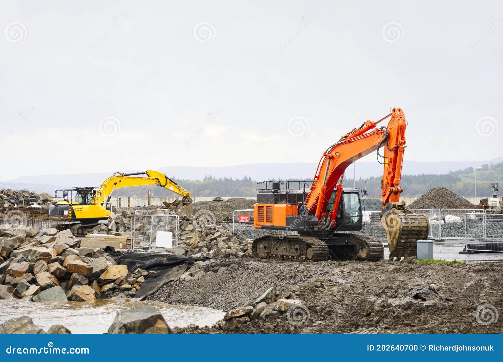 Construction Site Diggers Yellow and Orange during Excavation Stock ...