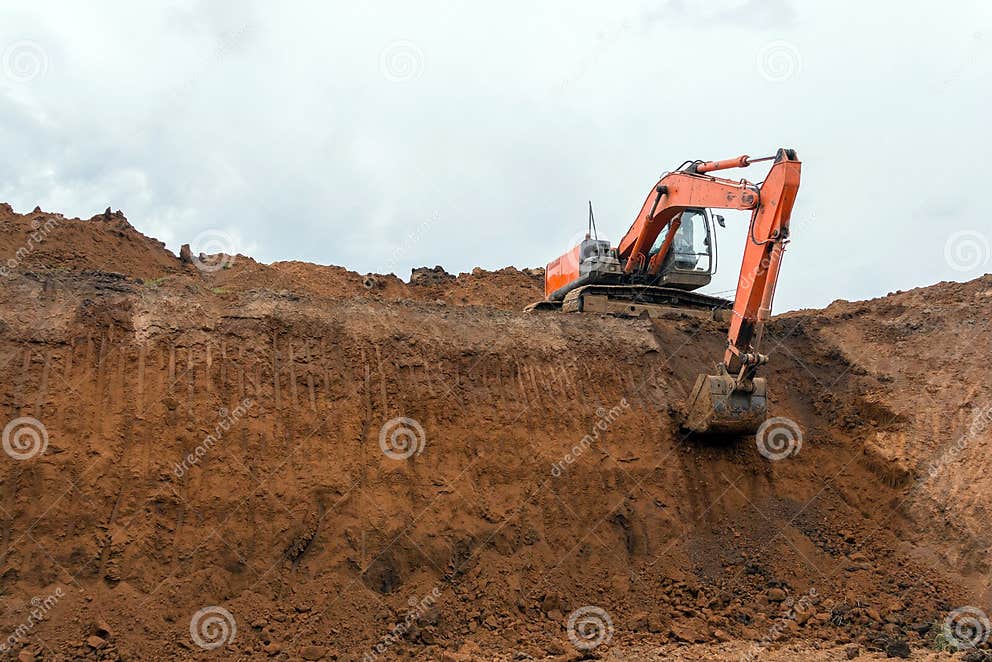 The Construction Site Excavator Digs a Deep Pit. Construction Machinery ...