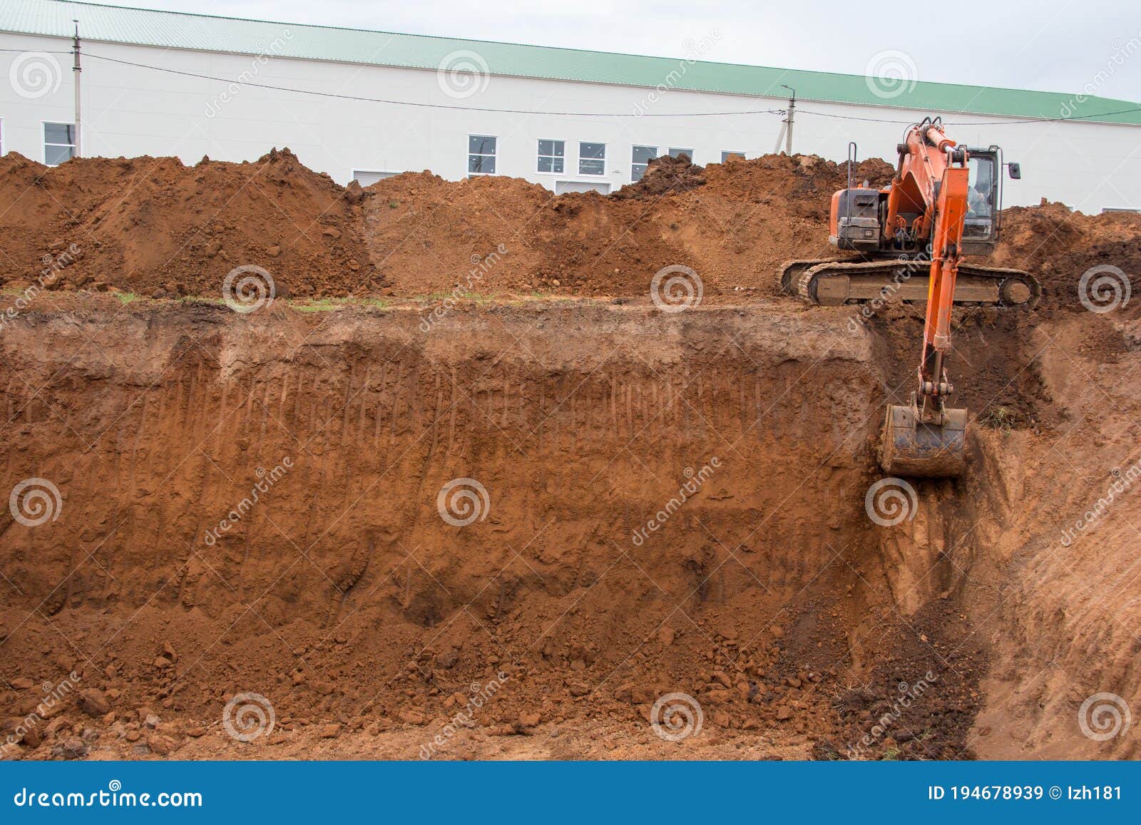 The Construction Site Excavator Digs a Deep Pit. Digger. Construction ...