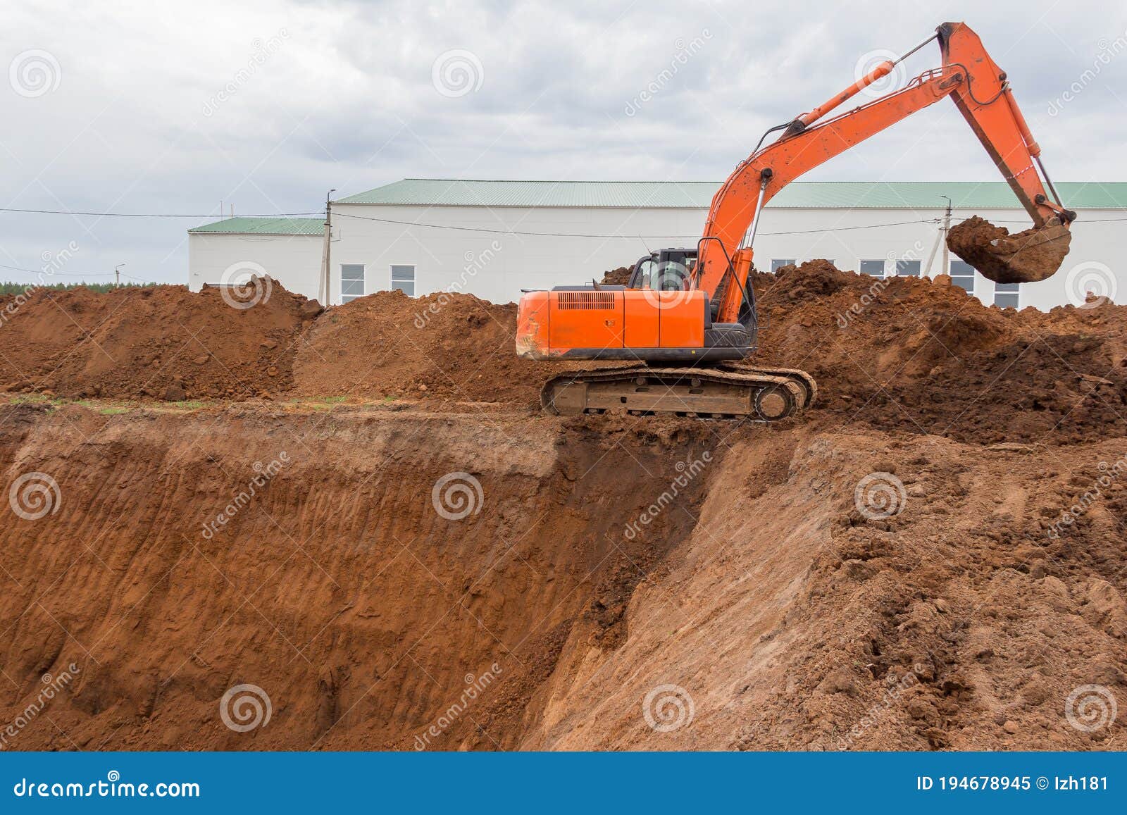 The Construction Site Excavator Digs a Deep Pit. Digger. Construction ...