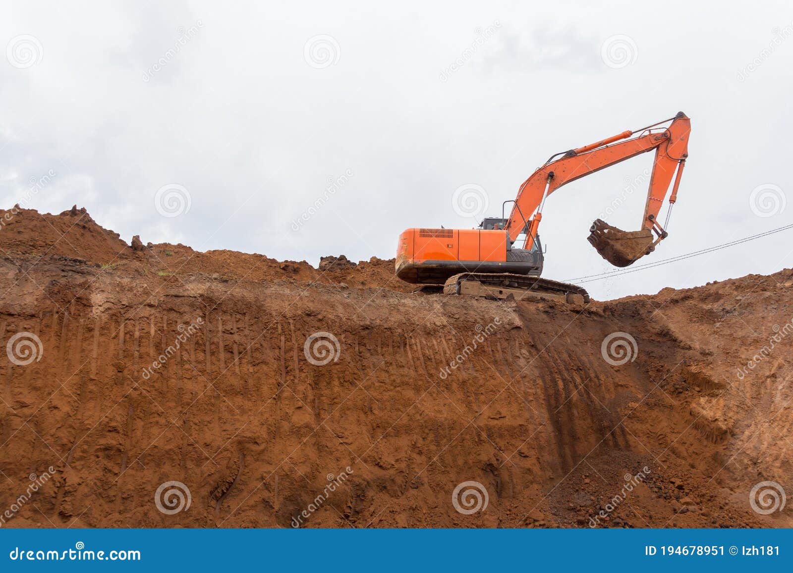 The Construction Site Excavator Digs a Deep Pit. Excavation at a ...