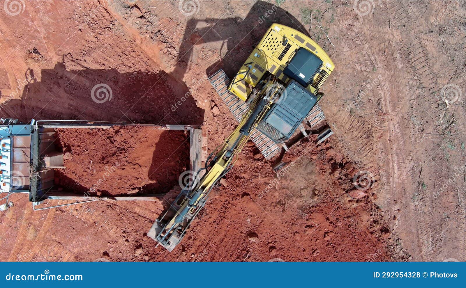 On Construction Site, Excavator Loads Earth into Machine, Thereby ...