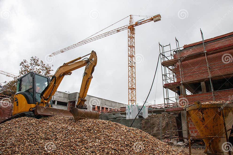 Construction Site Featuring a Crane and a Backhoe, Undergoing ...