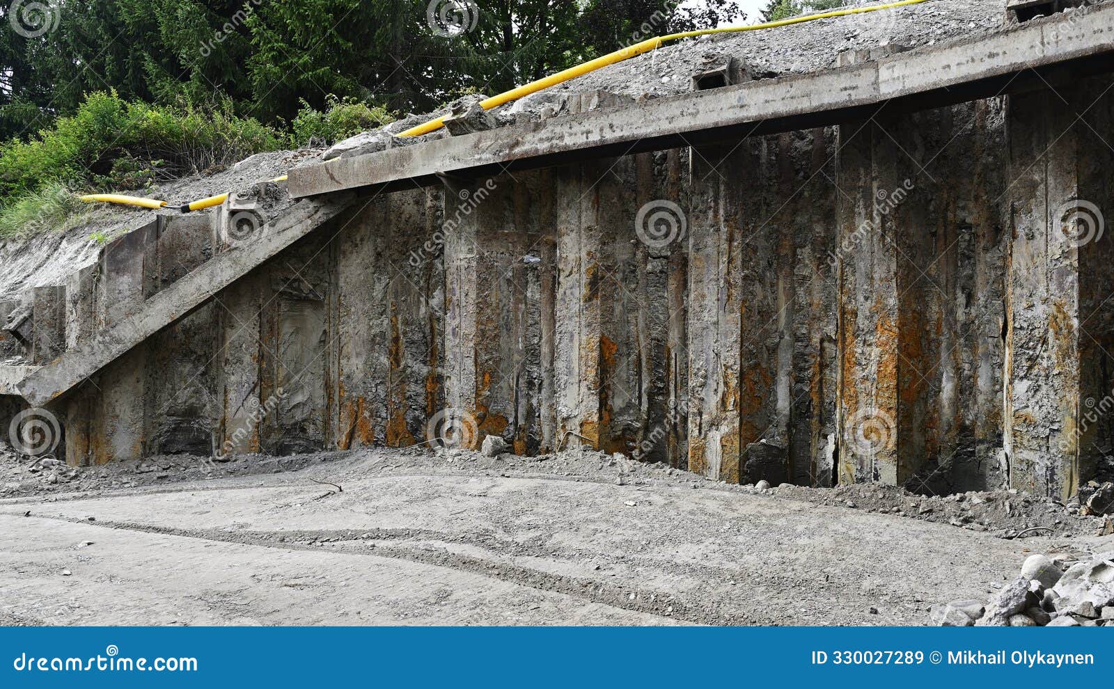 A Construction Site Featuring an Exposed Concrete Retaining Wall and ...