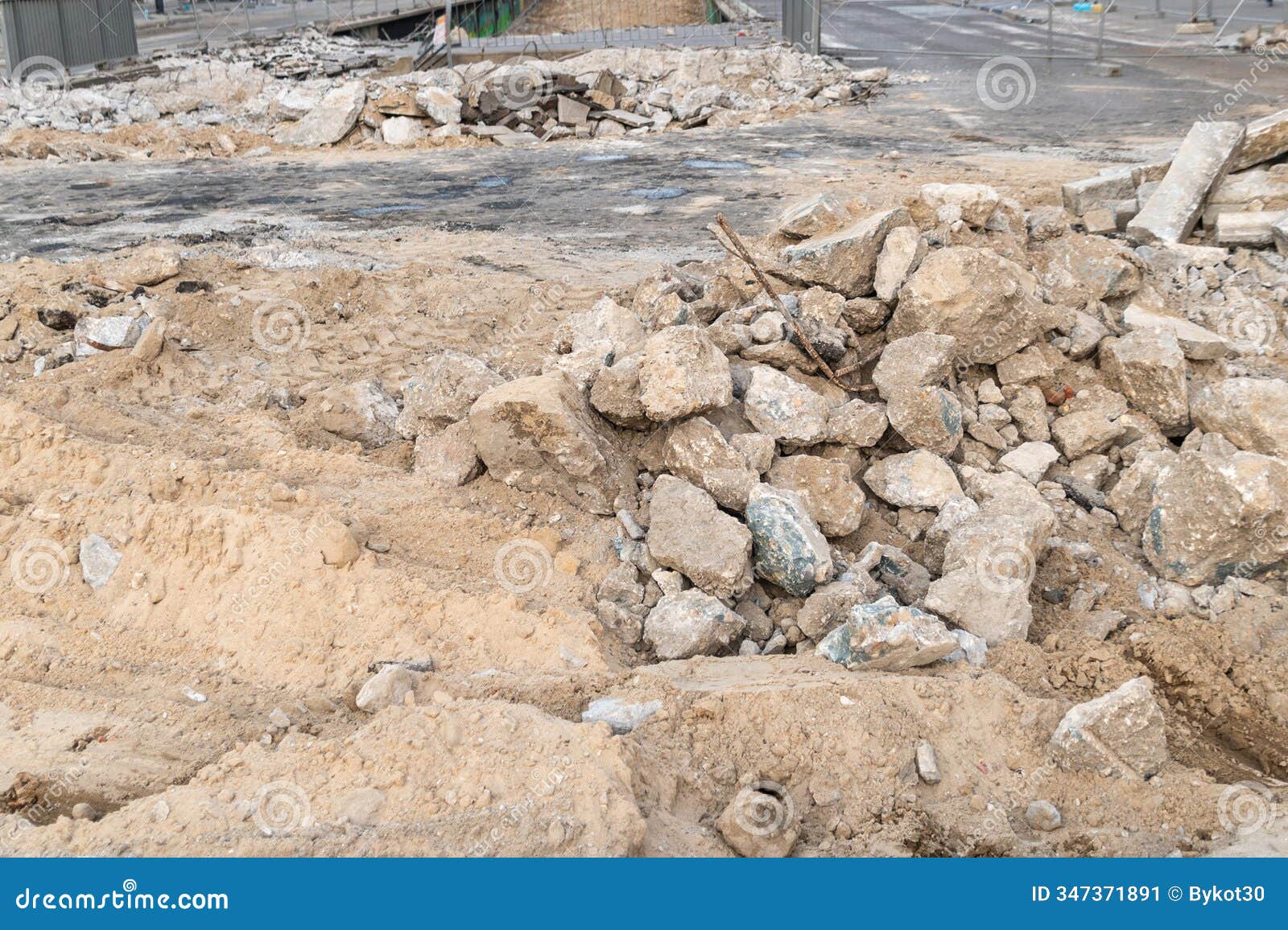 A Construction Site Featuring a Pile of Rubble and Sand, with Broken ...