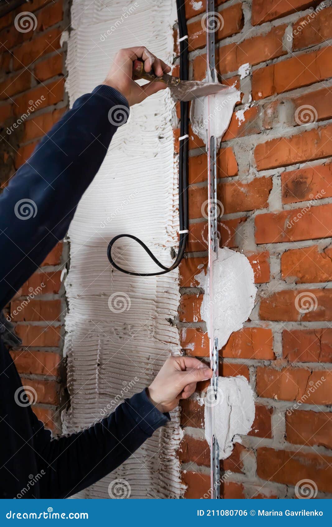 Construction Site, the Hands of the Master Install a Metal Guide for ...
