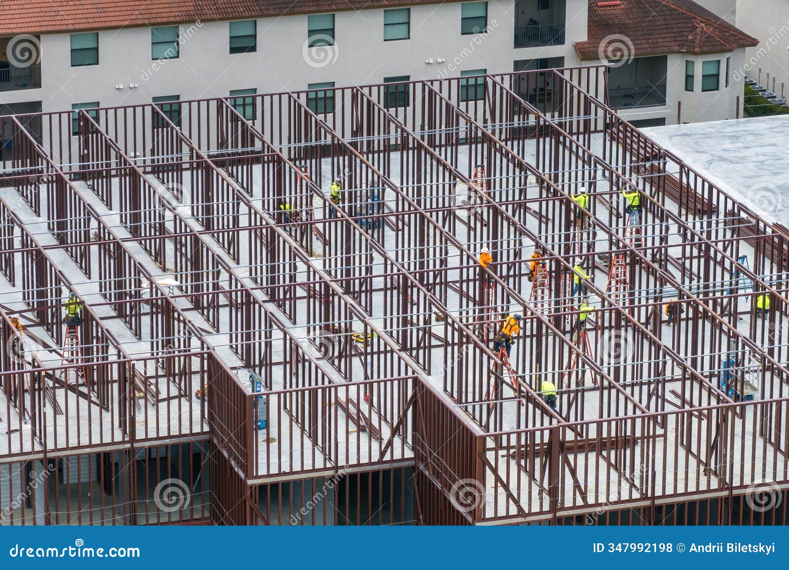 Construction Site with Hardhat Workers Assembling Metal Frame Walls ...