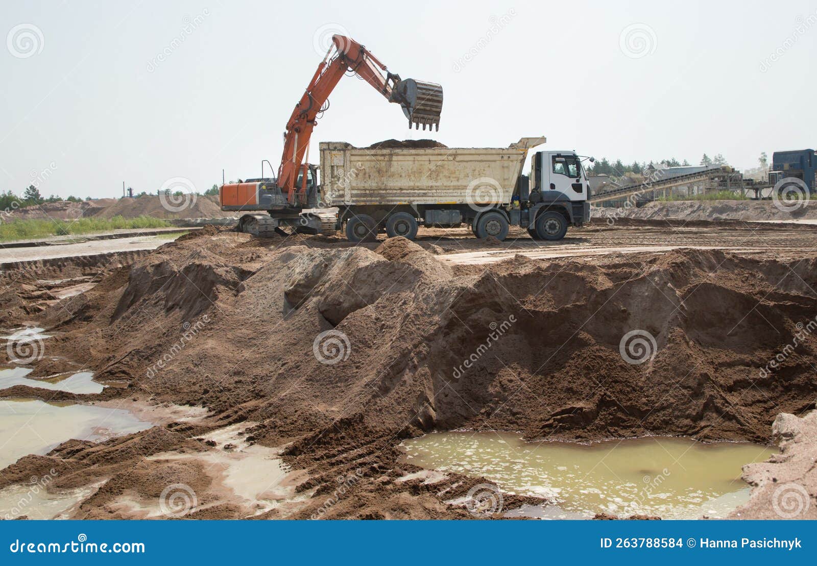 Large Working Machines - an Orange Crawler Excavator and a Gray Dump ...