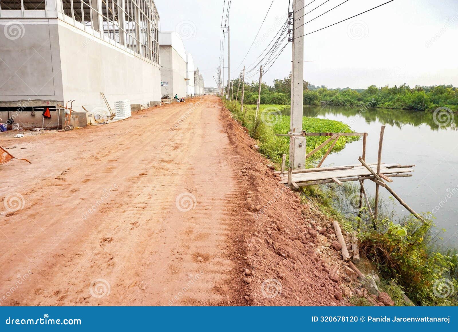 Construction Site : Laterite Road Factory Building and Lake Stock Photo ...