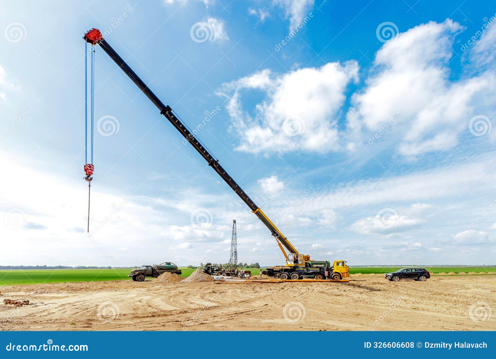 A Construction Site with a Lifting Crane and Workers Installing Water ...