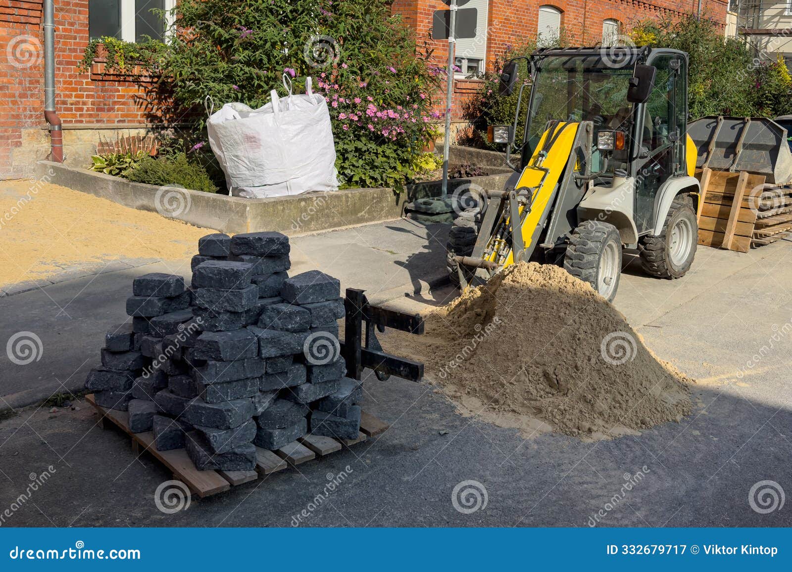 A Construction Site with a Loader Moving Sand and Paving Stones. Stock ...