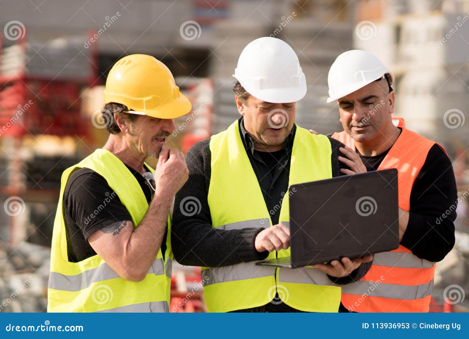 Construction Site Manager and Two Workers Using Pc Laptop Stock Image ...