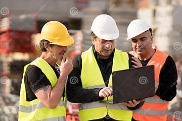 Construction Site Manager and Two Workers Using Pc Laptop Stock Image ...