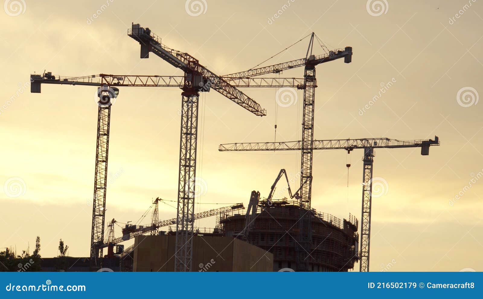 Construction Site with Multiple Cranes Working during the Sunset ...