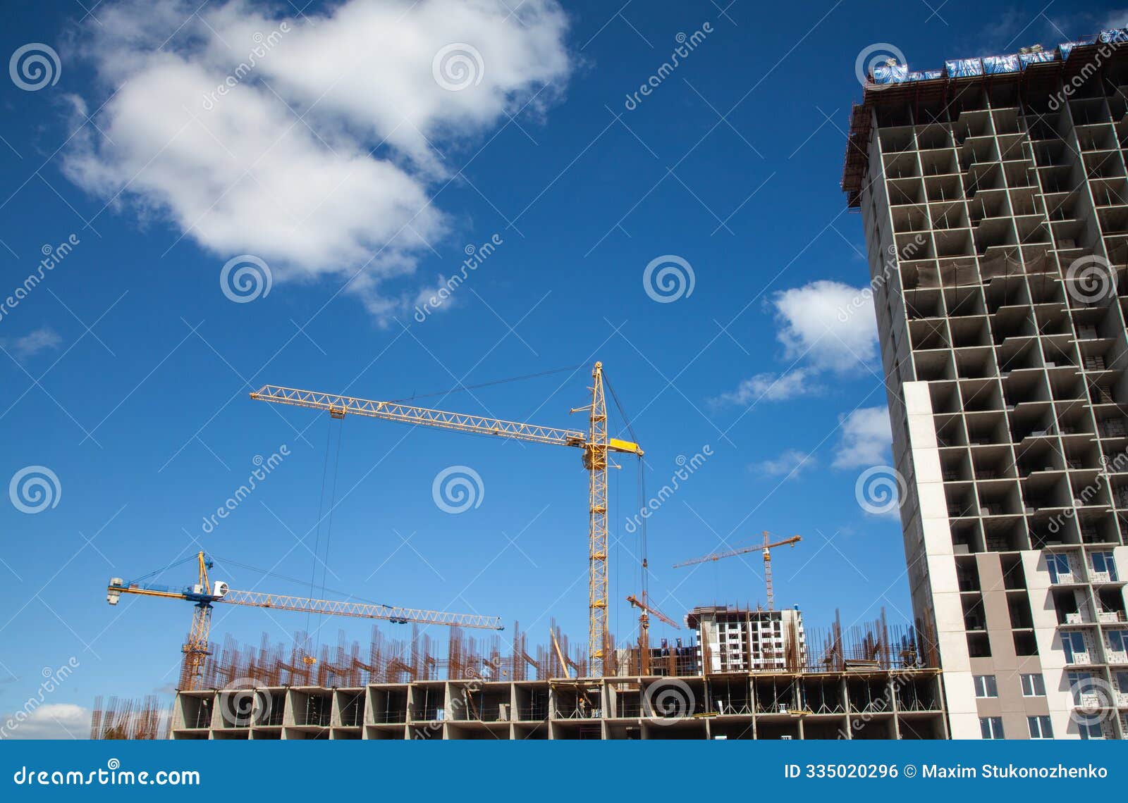 Construction Site with Multiple Tall Cranes Working on Building a High ...